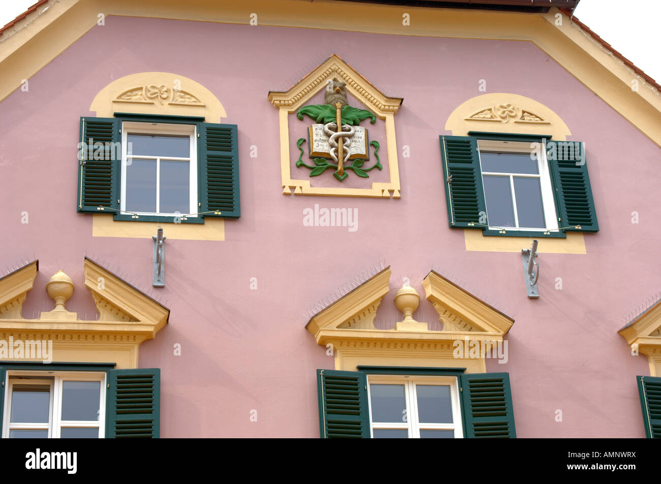 Baroque window with an old apothecary crest on a traditional Austrian ...