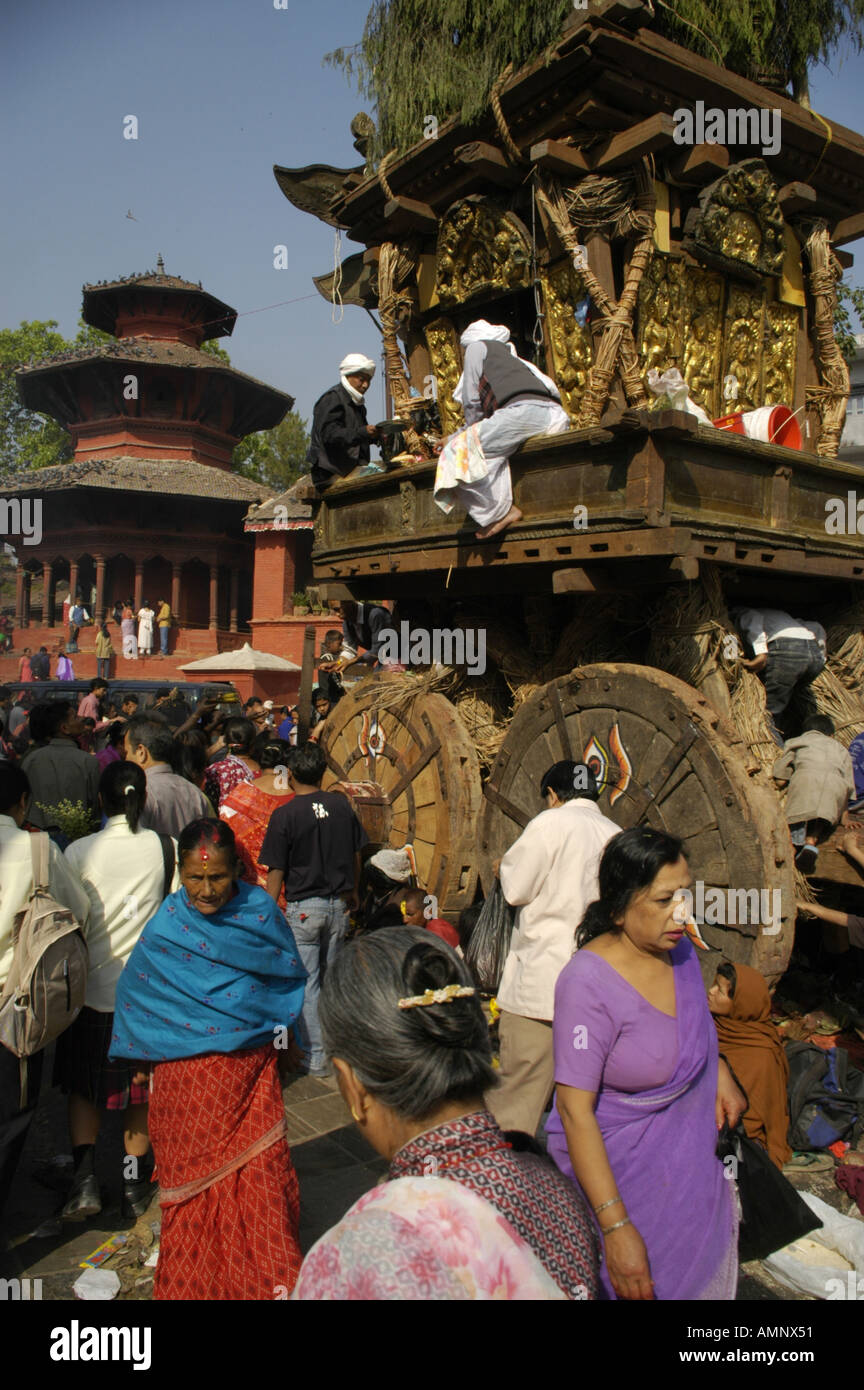 Believers at the chariot of Seto Macchendranath with a temple of Durbar ...