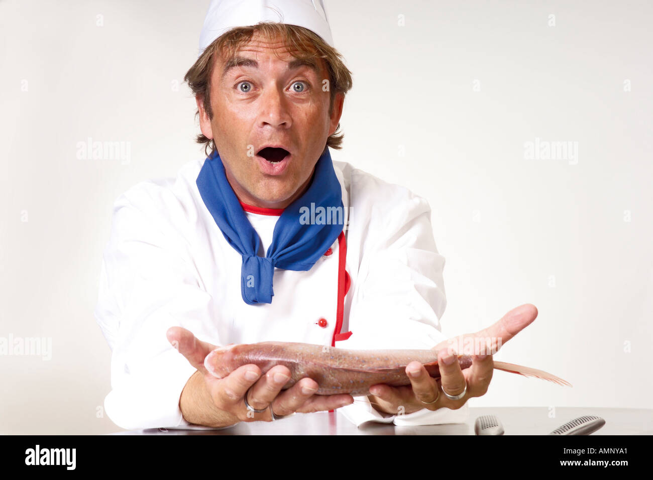 Cook holding fresh fish Stock Photo - Alamy