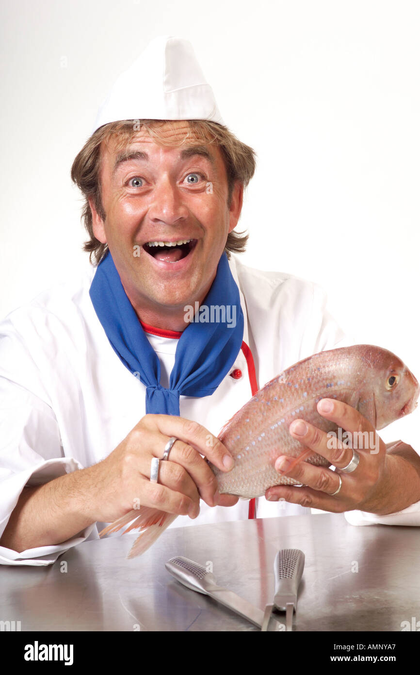 Cook holding fresh fish Stock Photo - Alamy