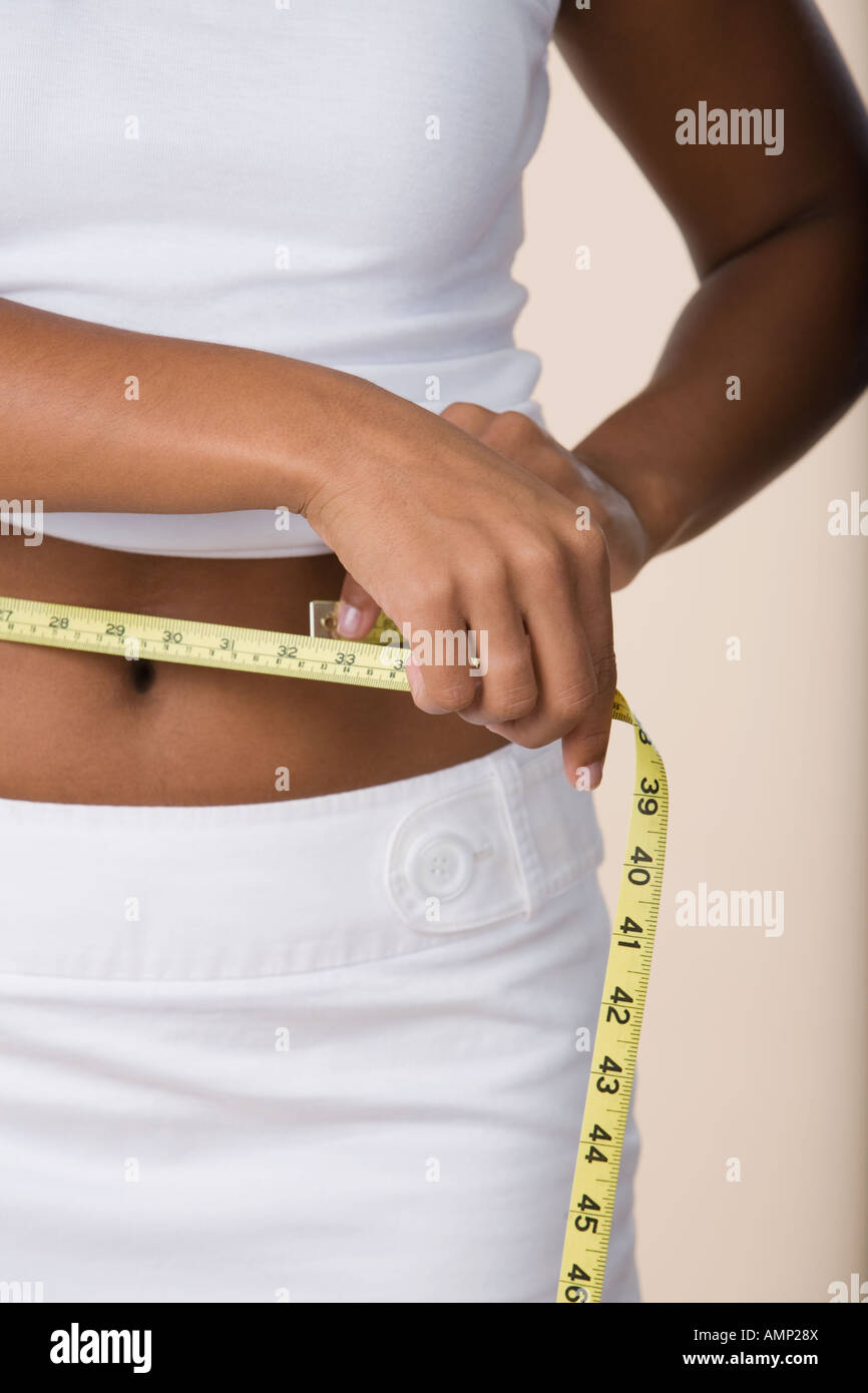 African woman measuring waist Stock Photo - Alamy