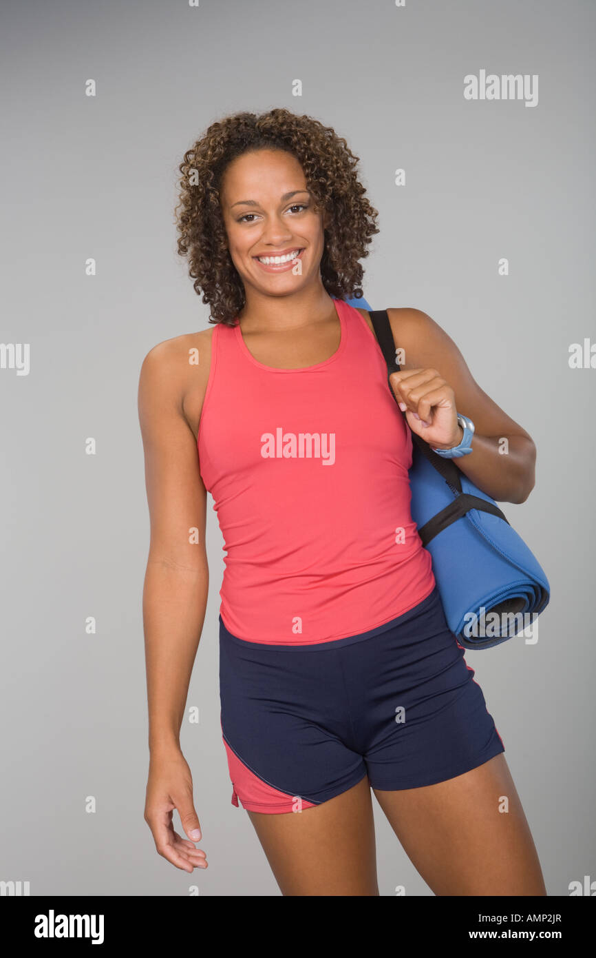 African woman carrying yoga mat Stock Photo - Alamy