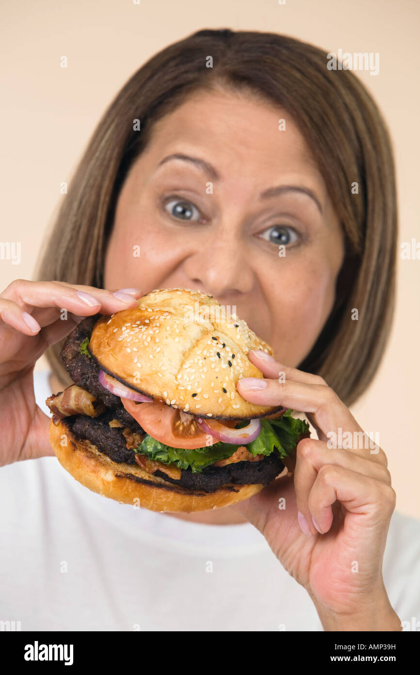 woman eating hamburger Stock Photo - Alamy