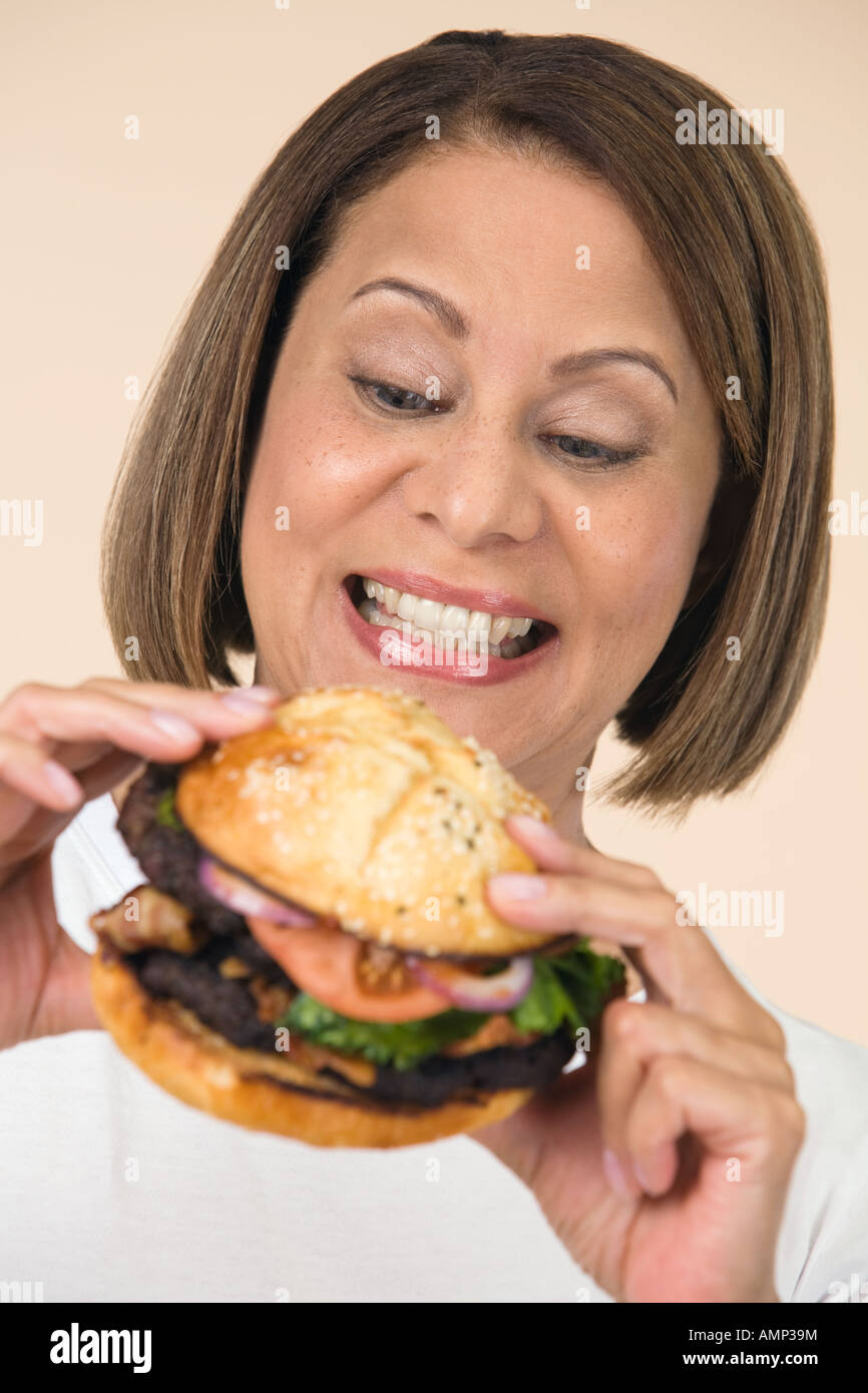 woman eating hamburger Stock Photo - Alamy
