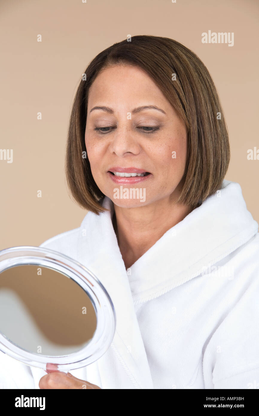 woman looking in mirror Stock Photo - Alamy
