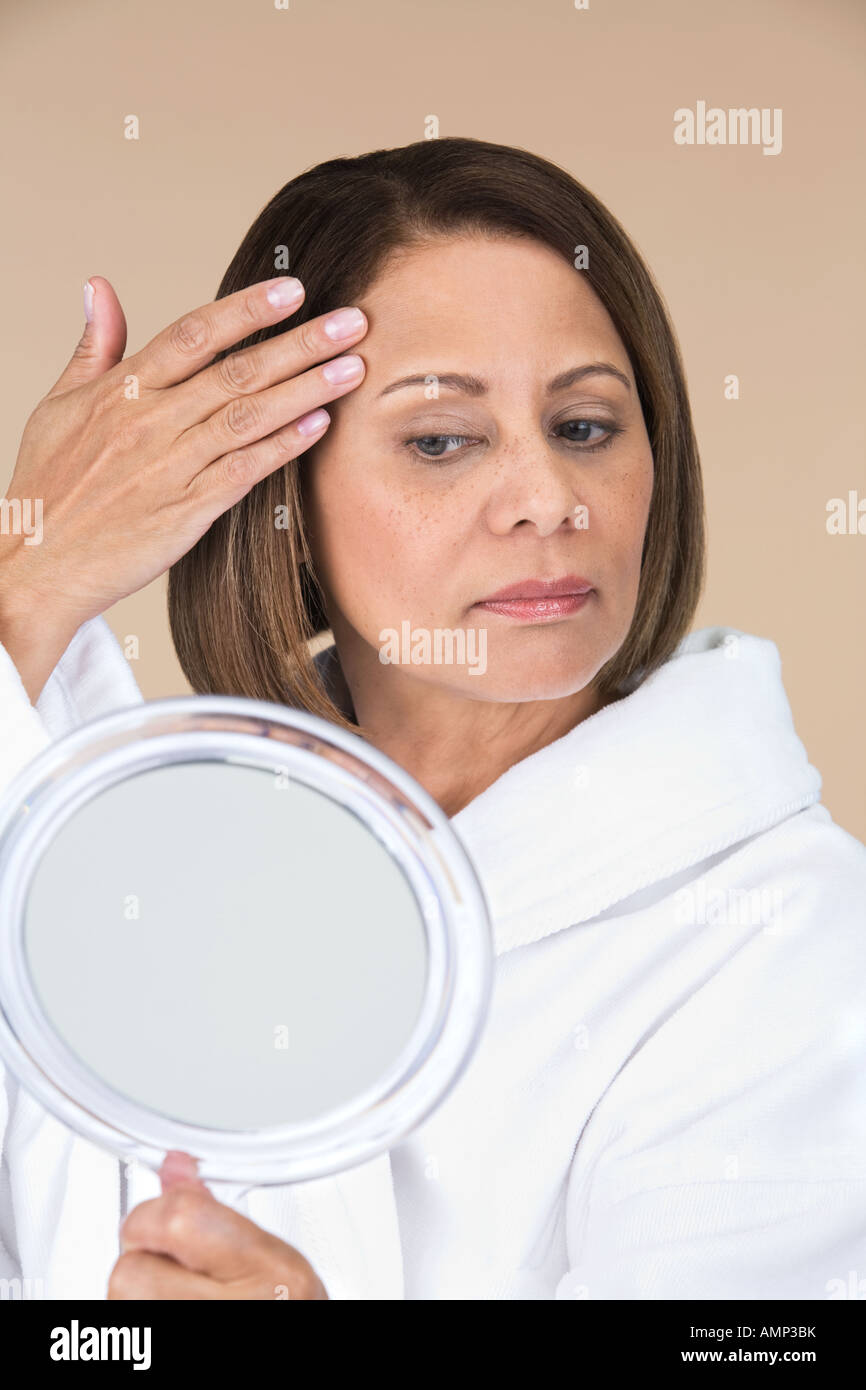 woman looking in mirror Stock Photo - Alamy