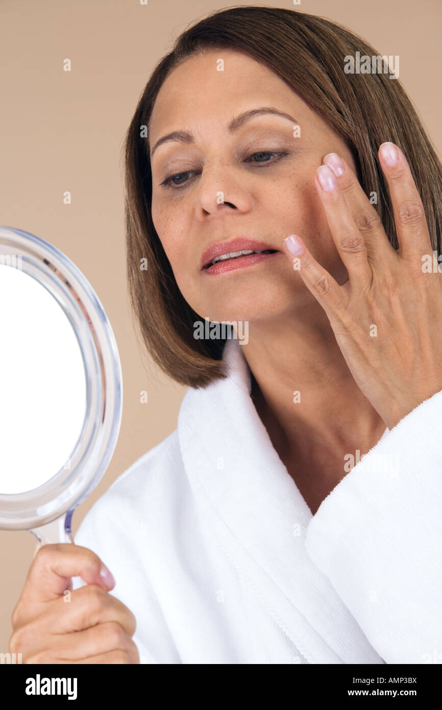 woman looking in mirror Stock Photo - Alamy