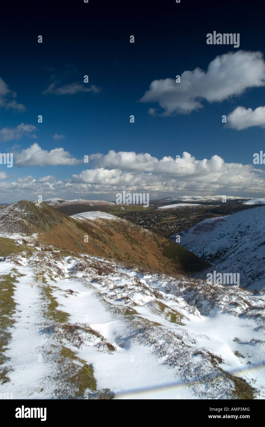 Winter scene of snowy hillside and valley with blue sky and large white ...