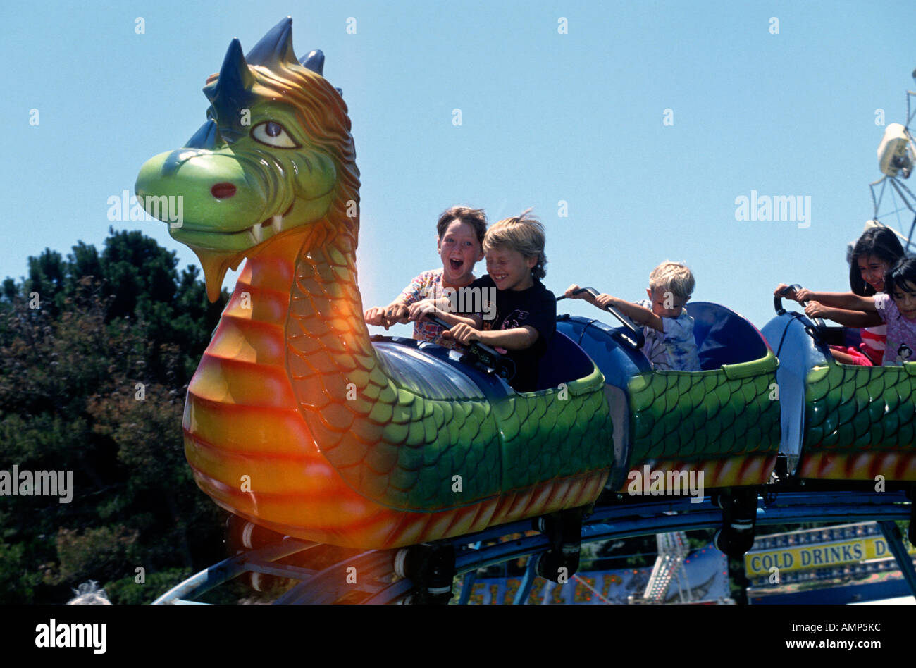 Children scream with delight while on an amusement ride Stock Photo - Alamy