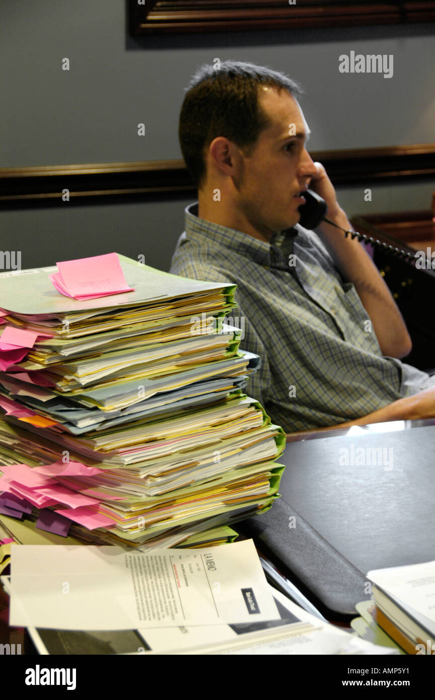 A banker is surrounded with paperwork on his desk Stock Photo - Alamy