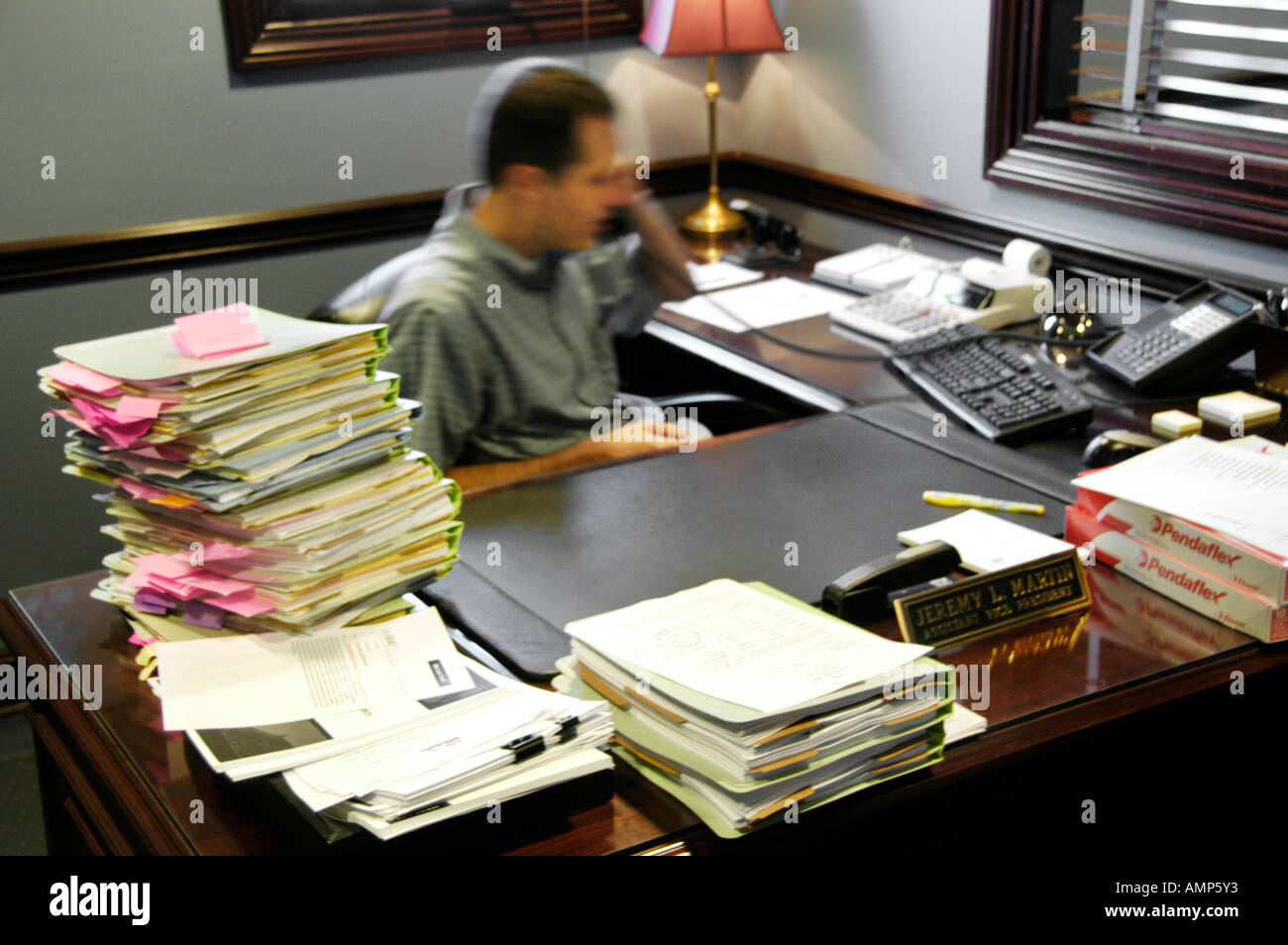 A banker is surrounded with paperwork on his desk Stock Photo - Alamy