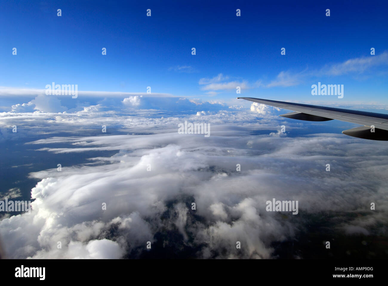 Passenger view of fantastic cloud formations forming bellow aircraft ...