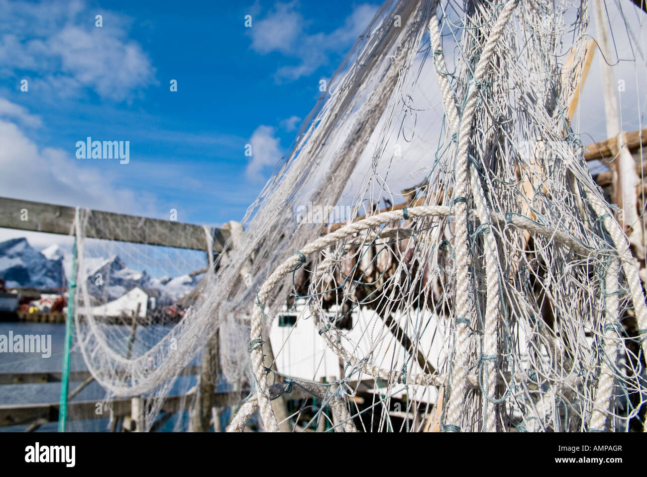 Tangled fishing nets hanging on wooden stockfish drying rack, called a ...