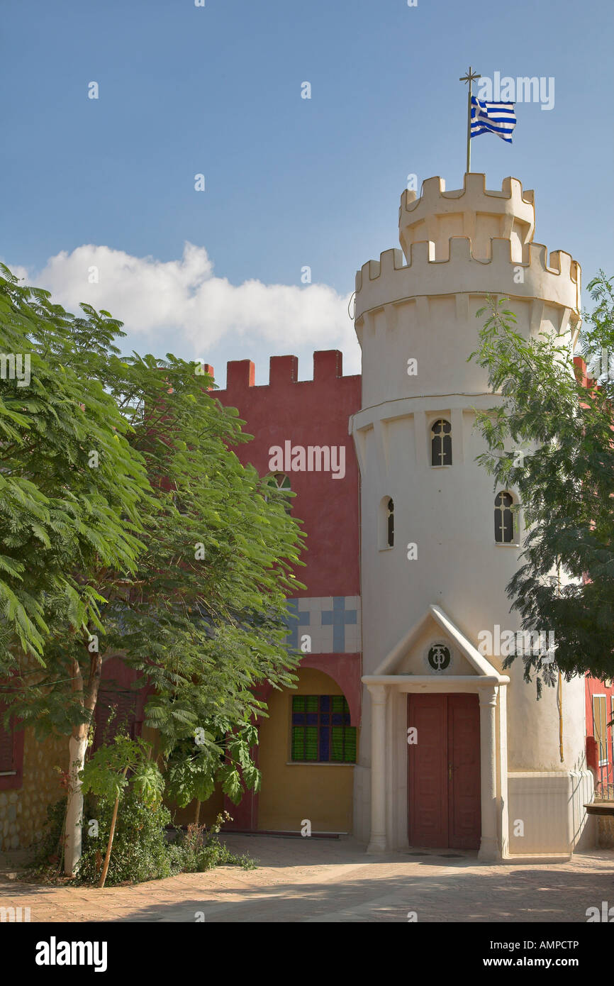 A tower of an orthodox monastery in desert and a flag at its top Stock ...
