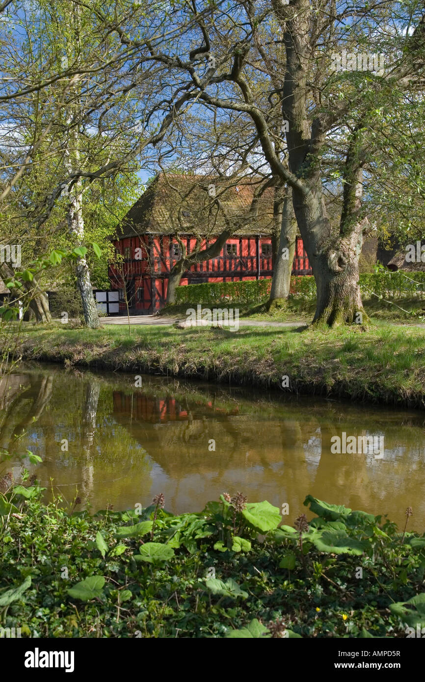 Traditional village cottage in front of a pond. The Funen Village ...