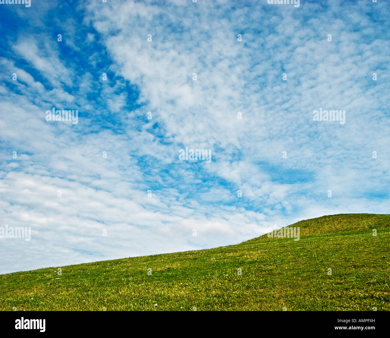 Hillside and cloudy sky Stock Photo - Alamy