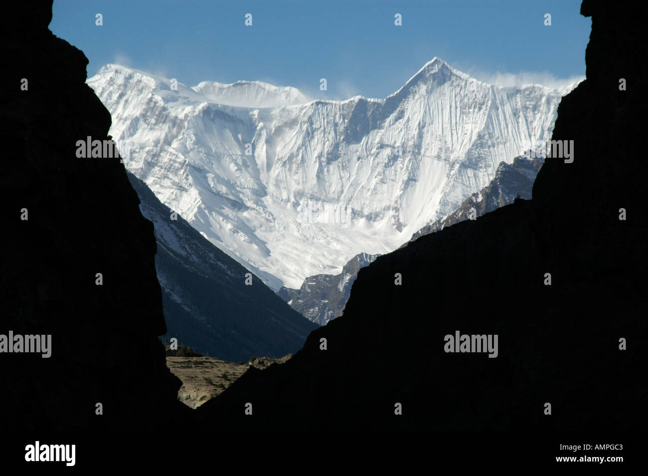 View through a gorge onto ice capped massive of Annapurna II Nar Phu ...