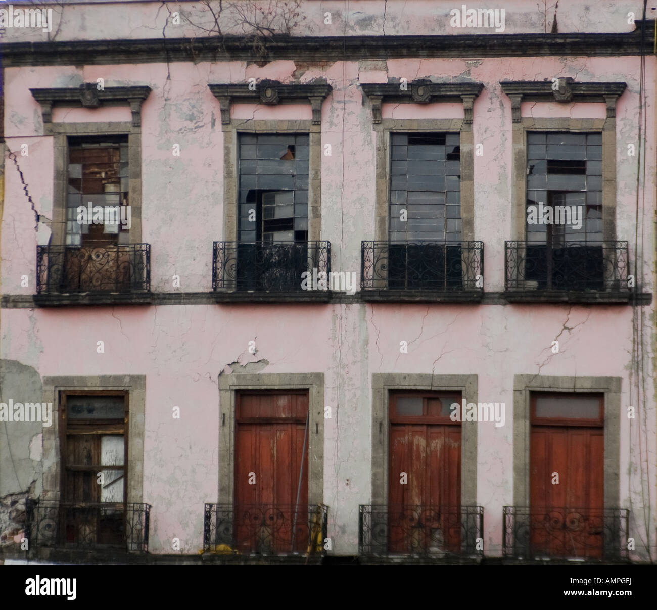 Old weathered pink building with many doors Stock Photo - Alamy