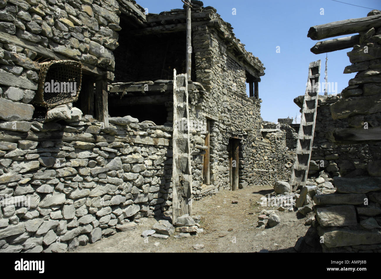 Flat roofed stone houses with wooden ladders in Manang Annapurna Region ...
