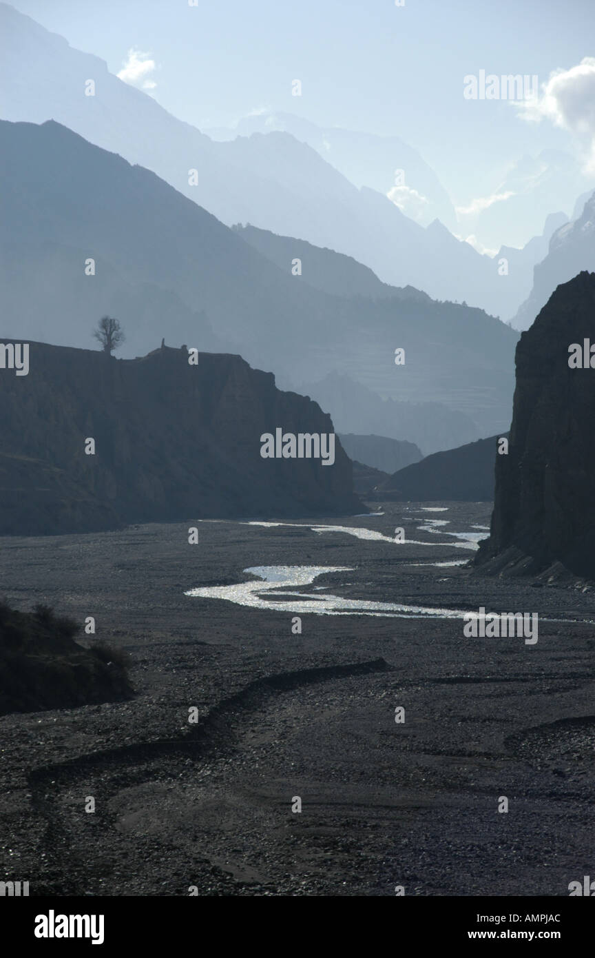 River below several misty mountain ranges after another near Manang ...