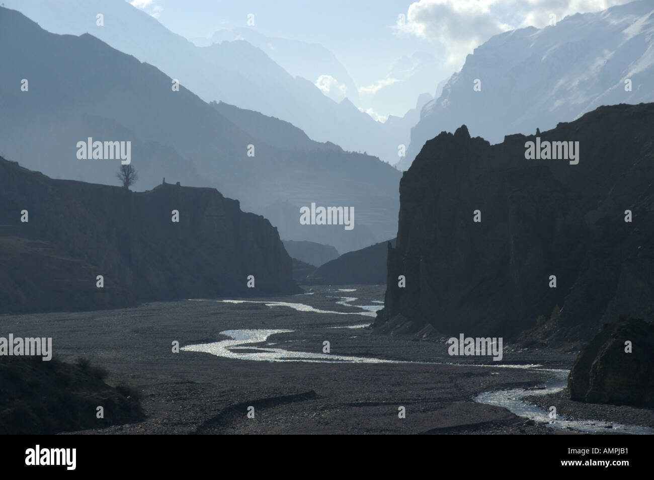 River below several misty mountain ranges after another near Manang ...