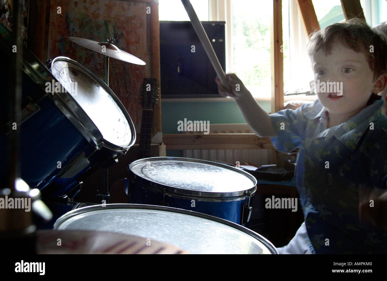 Drummer boy Lewis aged five playing on a set of drums Stock Photo - Alamy
