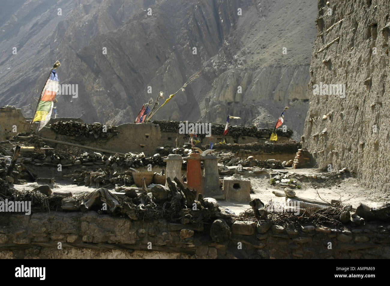Colourful prayer flags waft over flat stone roofs at the old fort ...