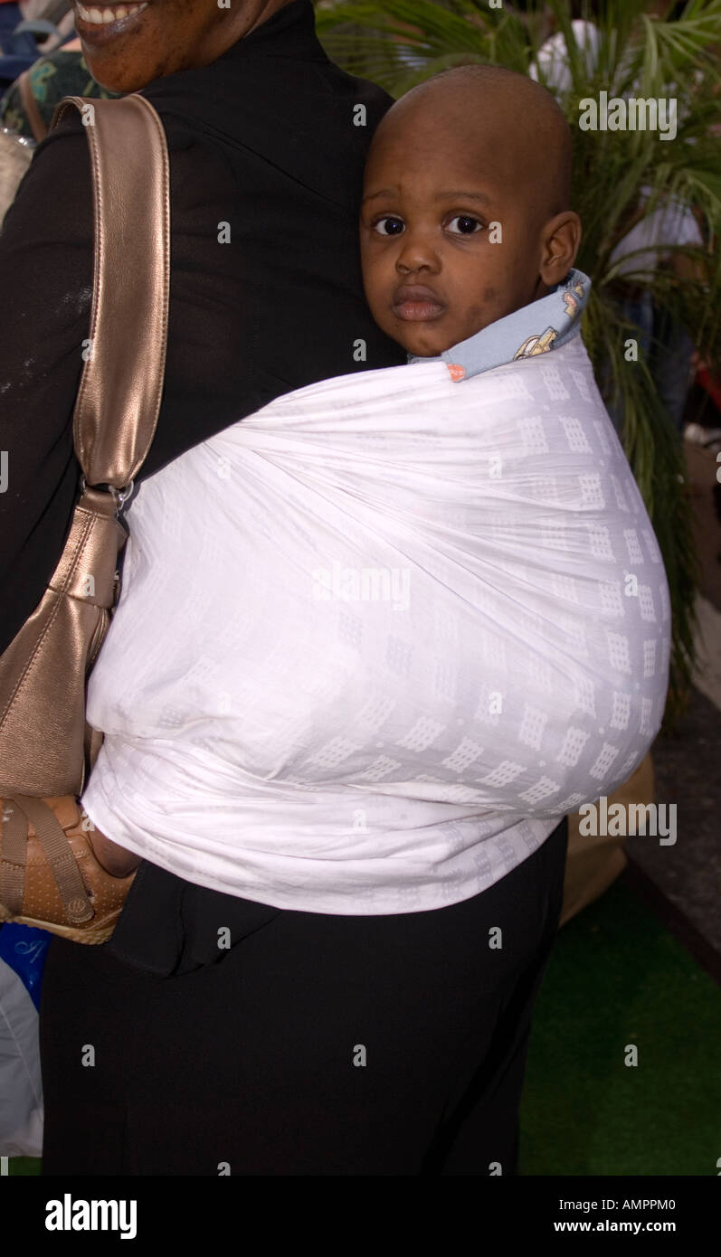Ethnic lady carrying her baby in sling like carrier Regents Street ...