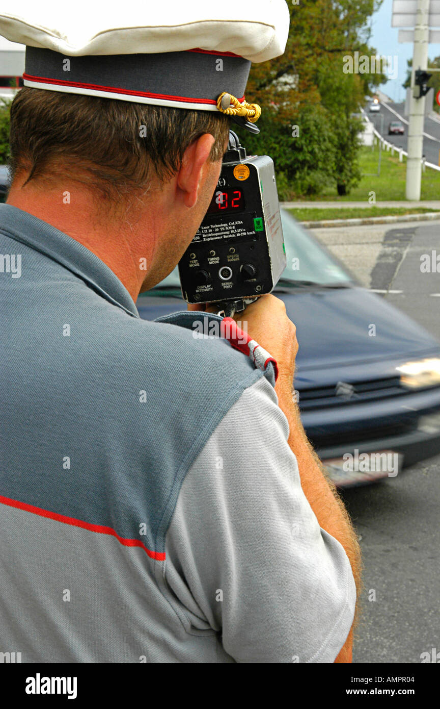 A Police Officer measuring speed with a Laser Gun Stock Photo - Alamy