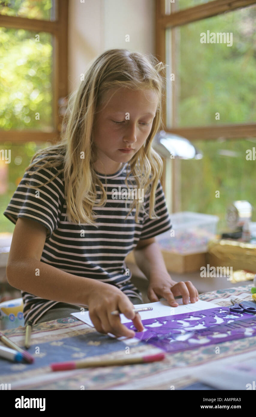 Girl using stencil for drawing Stock Photo - Alamy