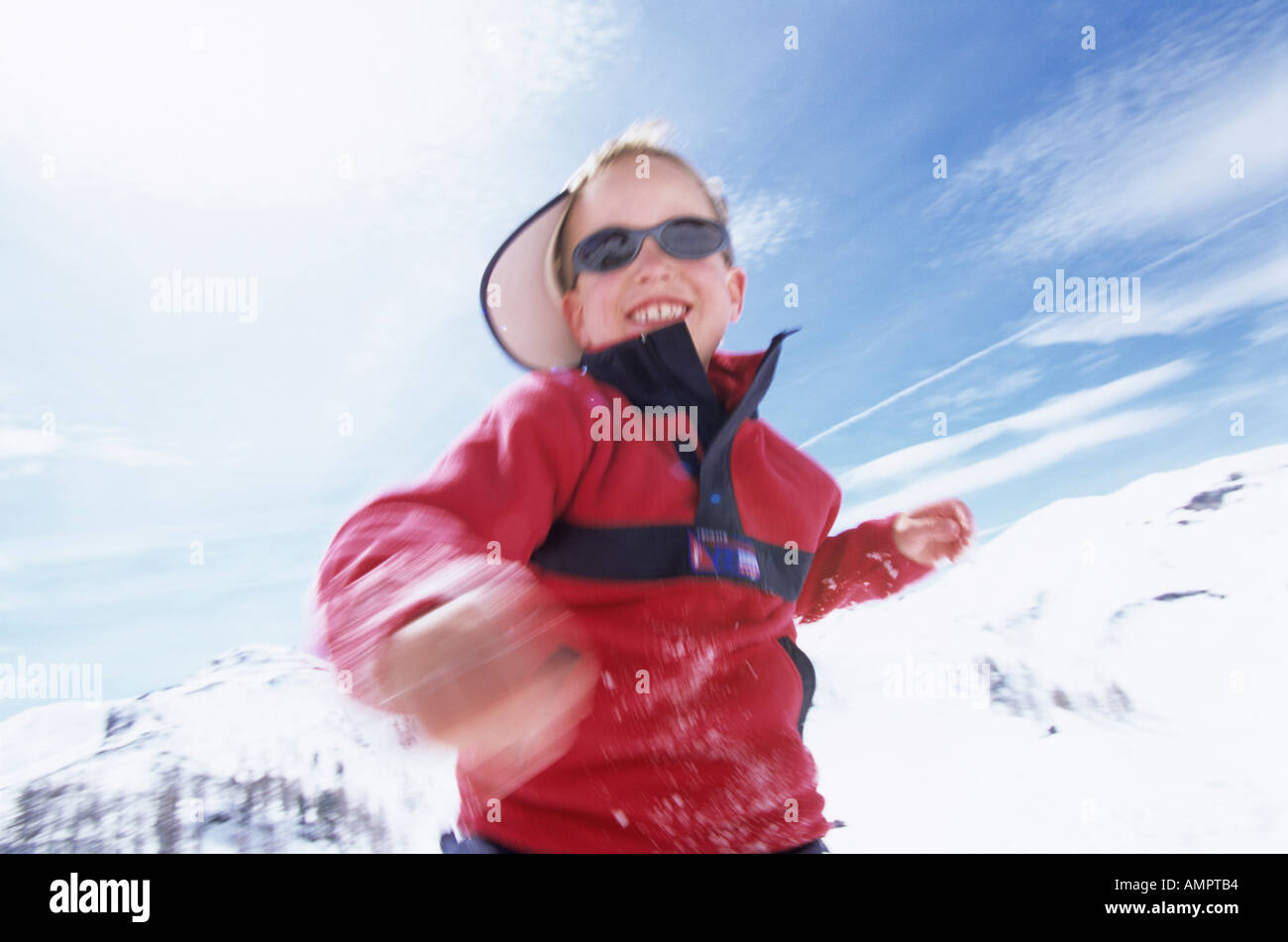 Boy running in snow Stock Photo - Alamy