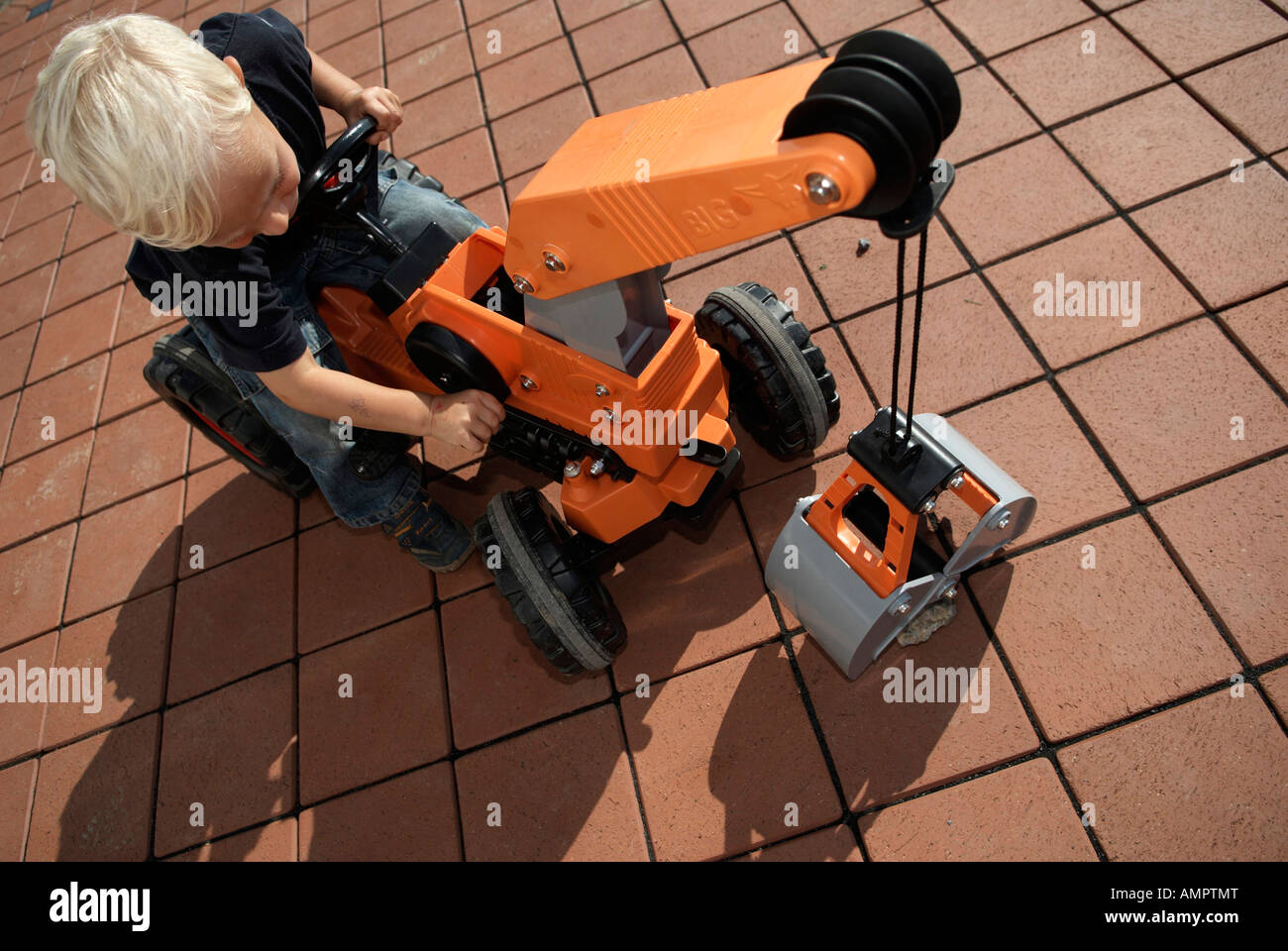 A three year old boy operating a functional toy excavator Stock Photo ...
