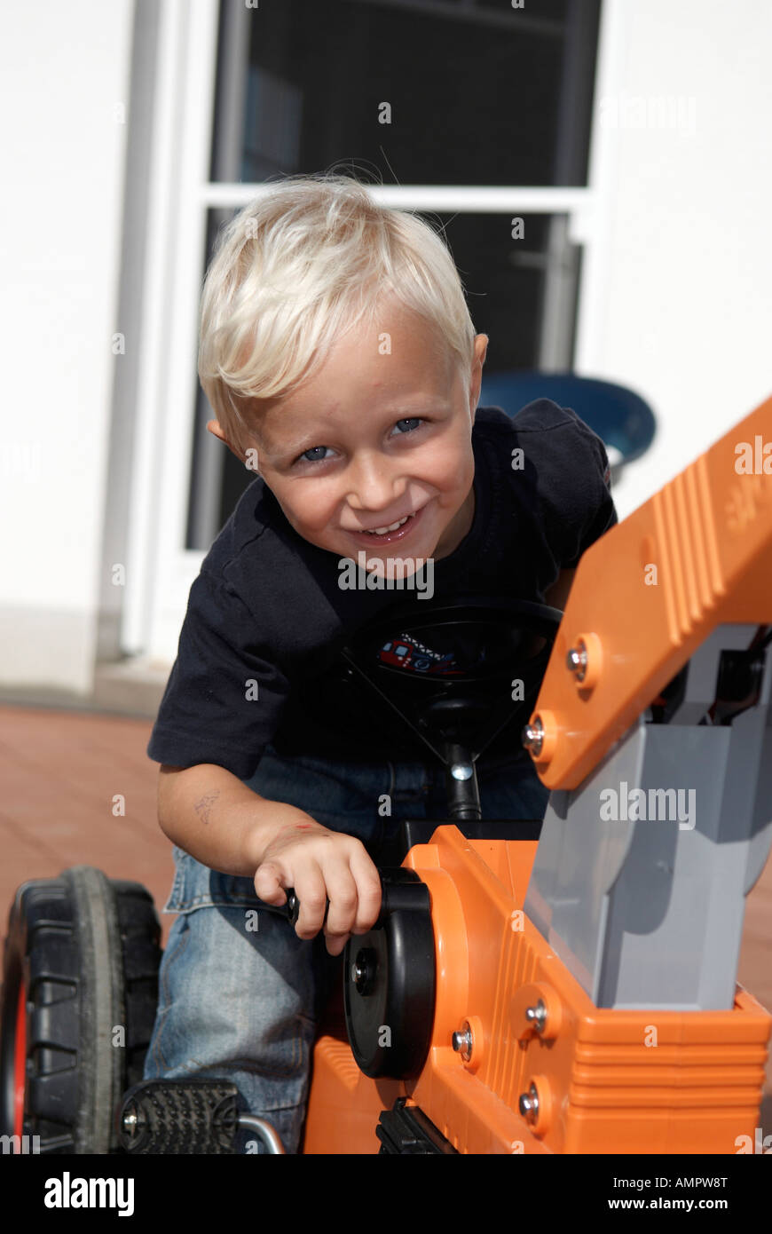 A three year old boy operating a functional toy excavator Stock Photo ...