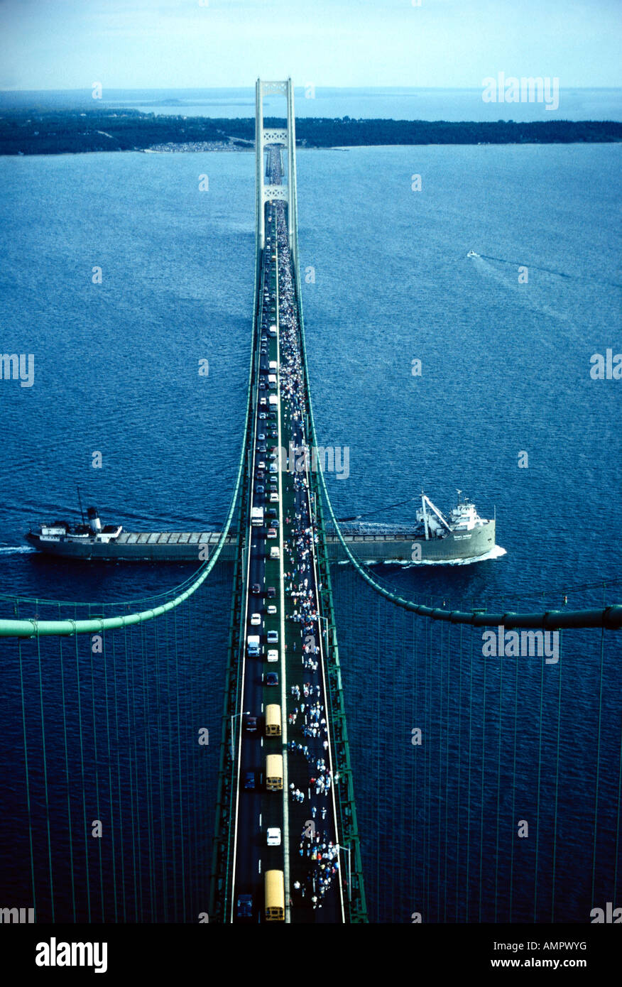 Great Lakes freighter passing under Mackinac Bridge during annual Labor ...