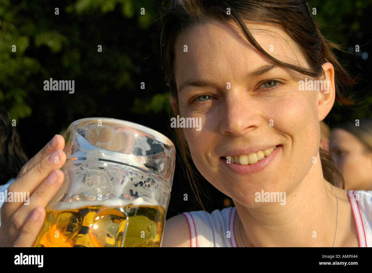 MR portrait smiling young woman drinks one mass one liter beer in a ...