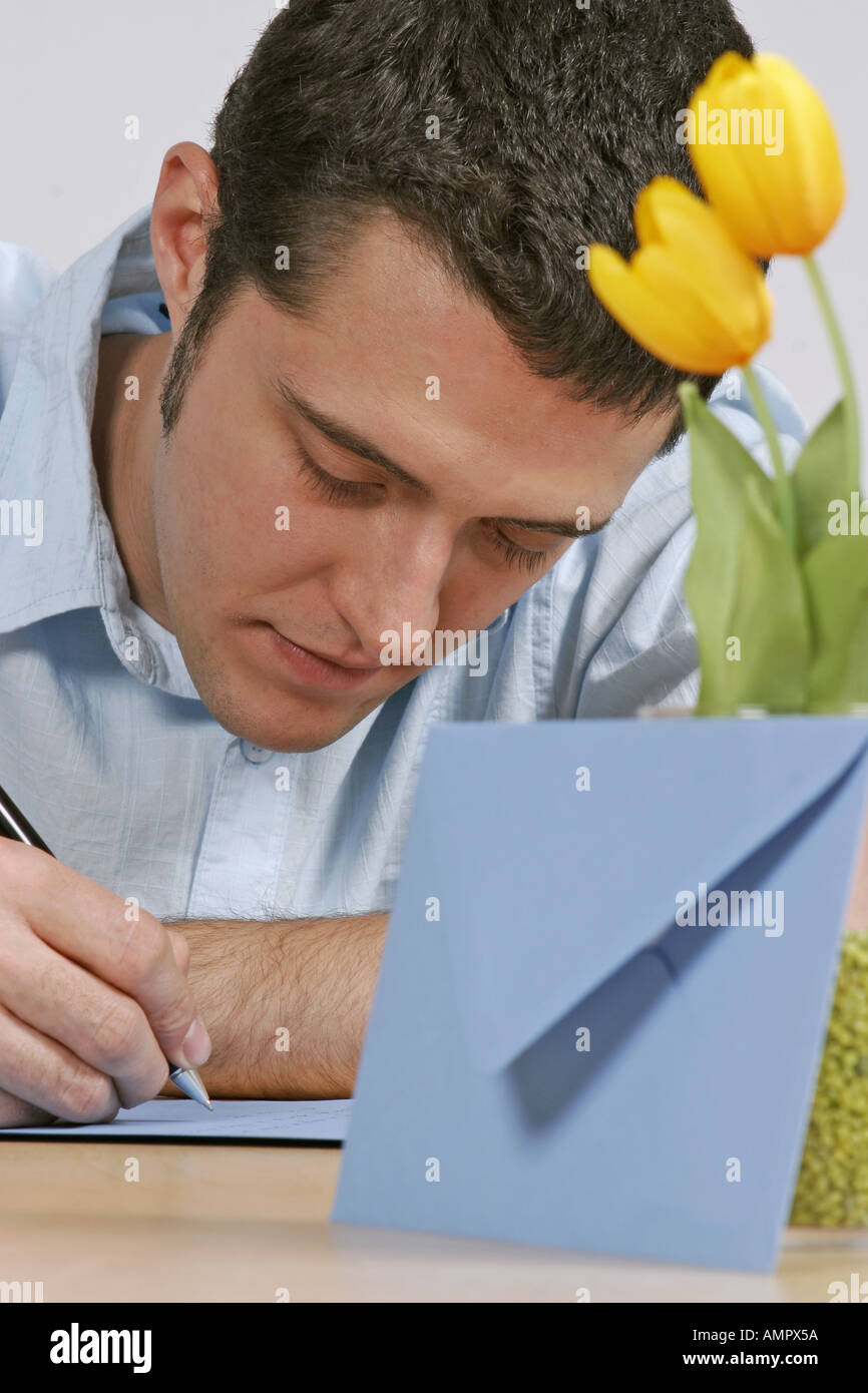 Young man writing letter Stock Photo - Alamy
