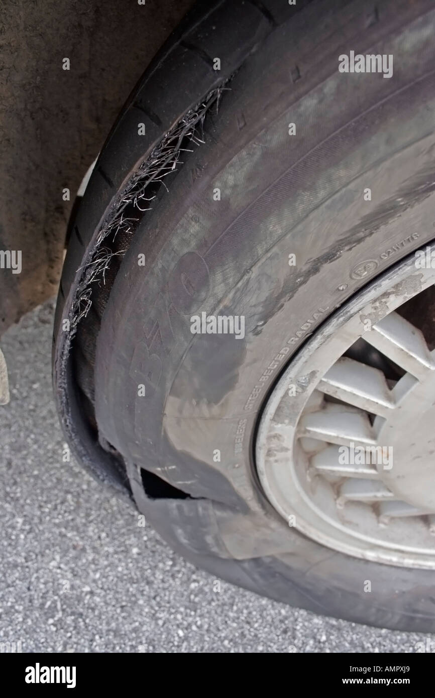 A blown out car tyre Stock Photo - Alamy