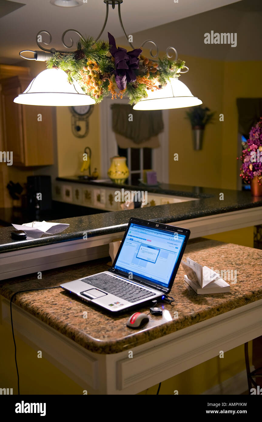 Home office laptop computer sitting on a counter under two lights Stock ...