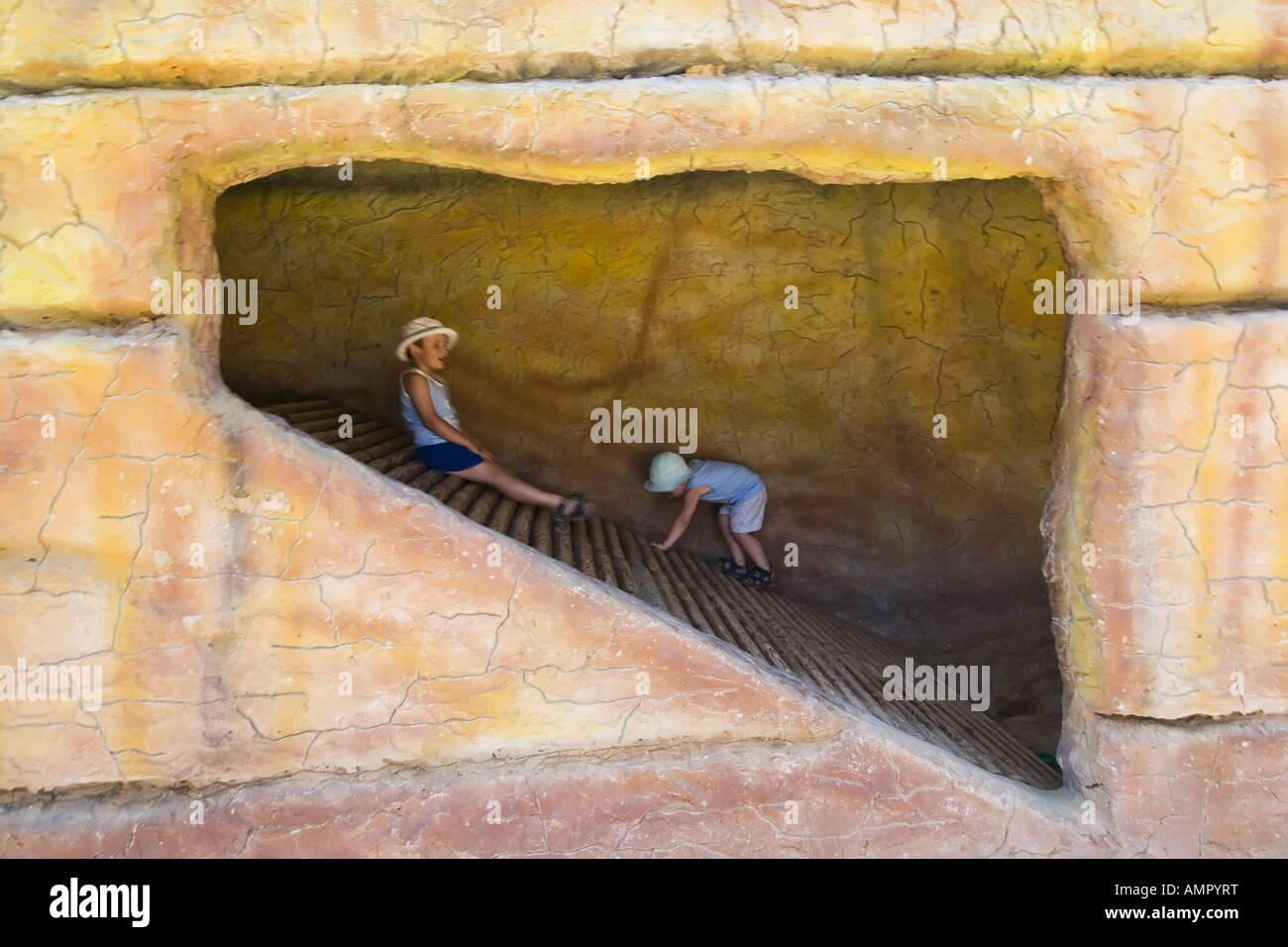 kids play in cave on playground, Children playing in cave Stock Photo ...