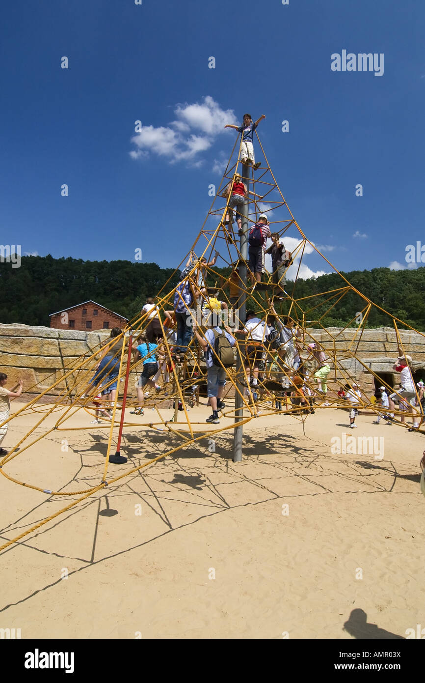 Boys and girls playing on rope climbing frame, Children on playground ...