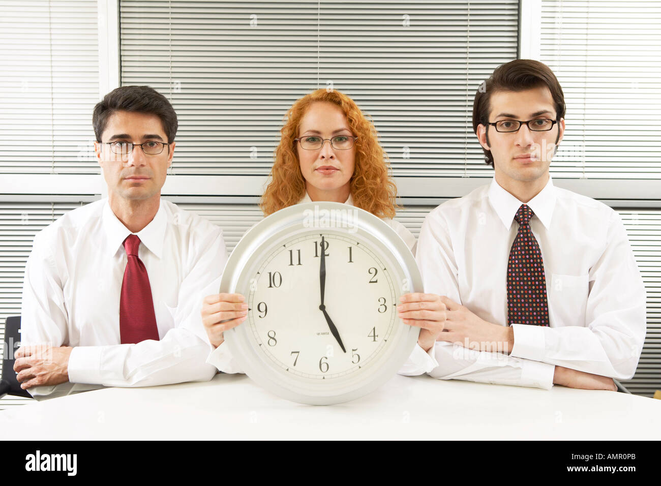Portrait of Business People With Clock Stock Photo - Alamy