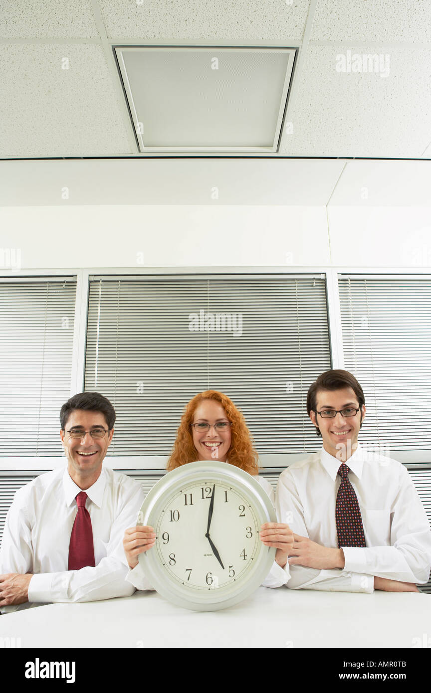 Portrait of Business People With Clock Stock Photo - Alamy