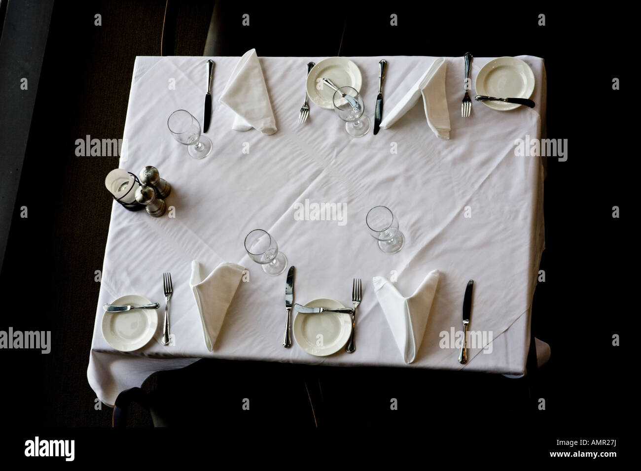 A square table set for dinner Stock Photo - Alamy