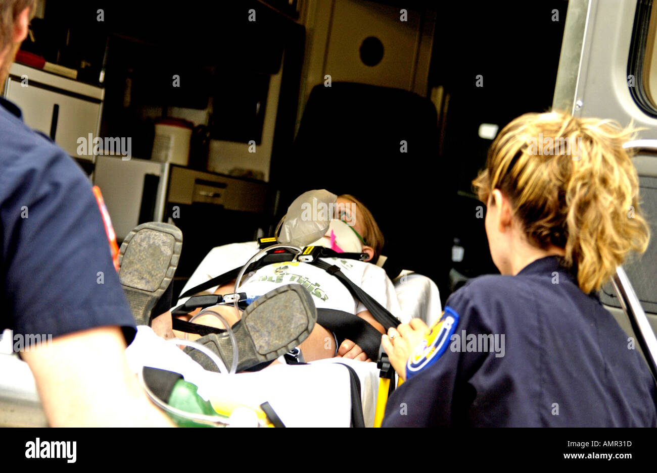 EMTs loading patient into ambulance Stock Photo - Alamy