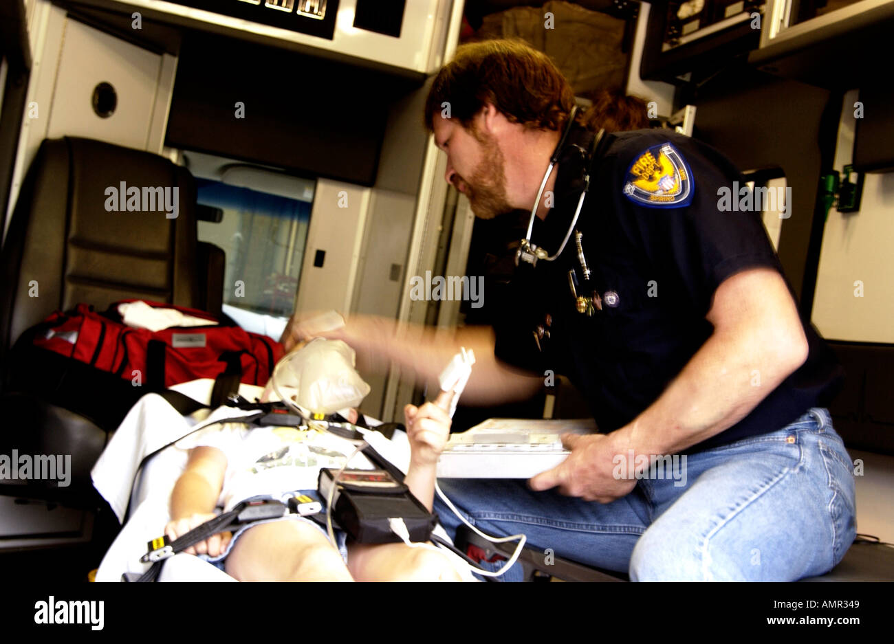 EMT with patient in ambulance Stock Photo - Alamy