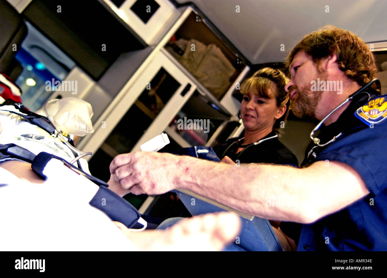 EMTs with patient in ambulance Stock Photo - Alamy