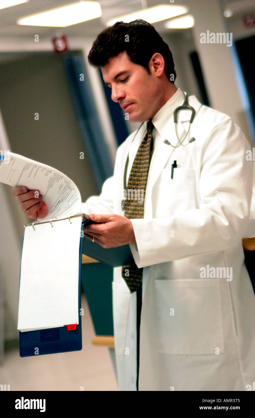 Doctor looking at patient chart Doctor looking at patient chart Stock ...