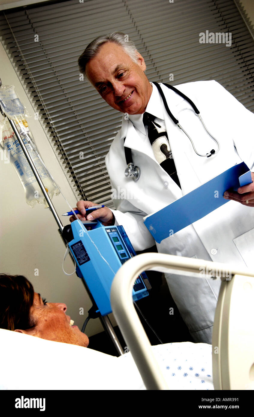 Doctor looking at patient chart Stock Photo - Alamy