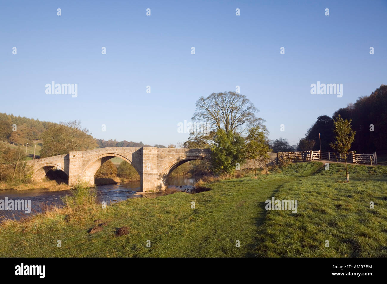 Old arched stone bridge over River Wharfe with Dales Way path in ...