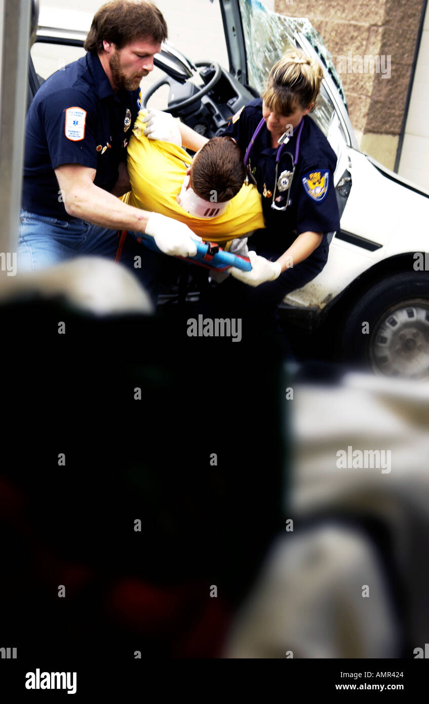 EMTs helping victim from car crash EMTs helping victim from car Stock ...